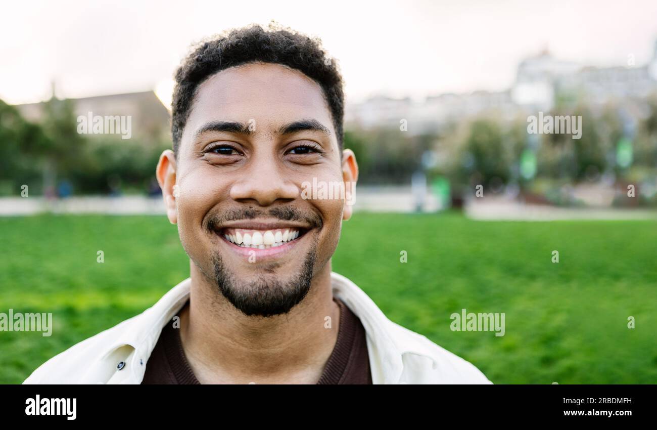 Smiling portrait of young gen z man looking at camera outdoors Stock ...