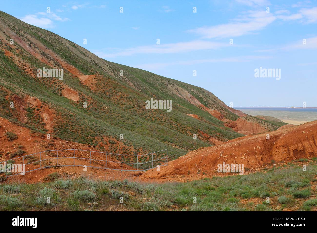 Rainbow colorful stones with the green grassy slopes, Baskunchak lake ...