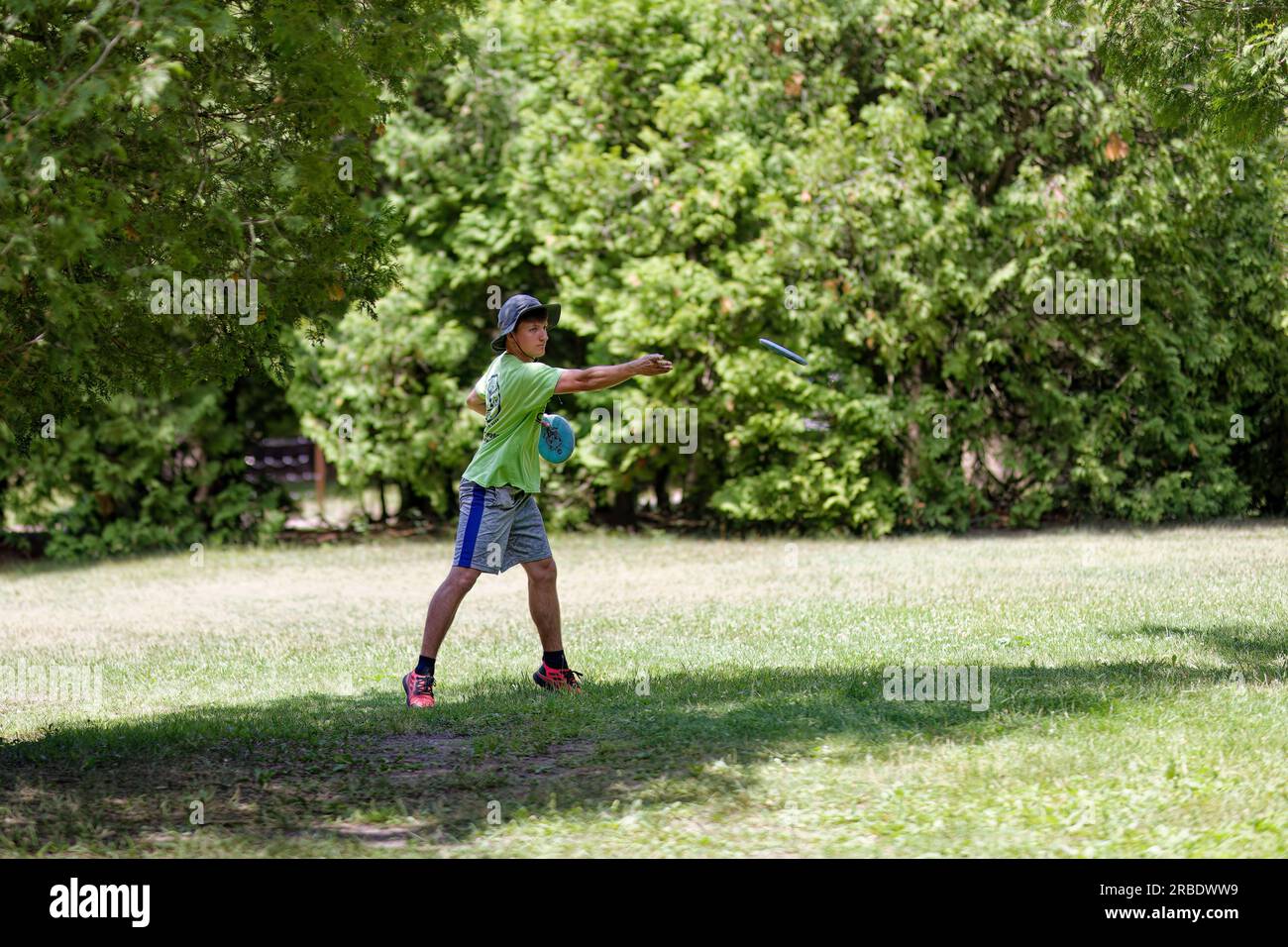 Manitowoc WI Disc golf. A player throwing a concave plastic disc into a ...
