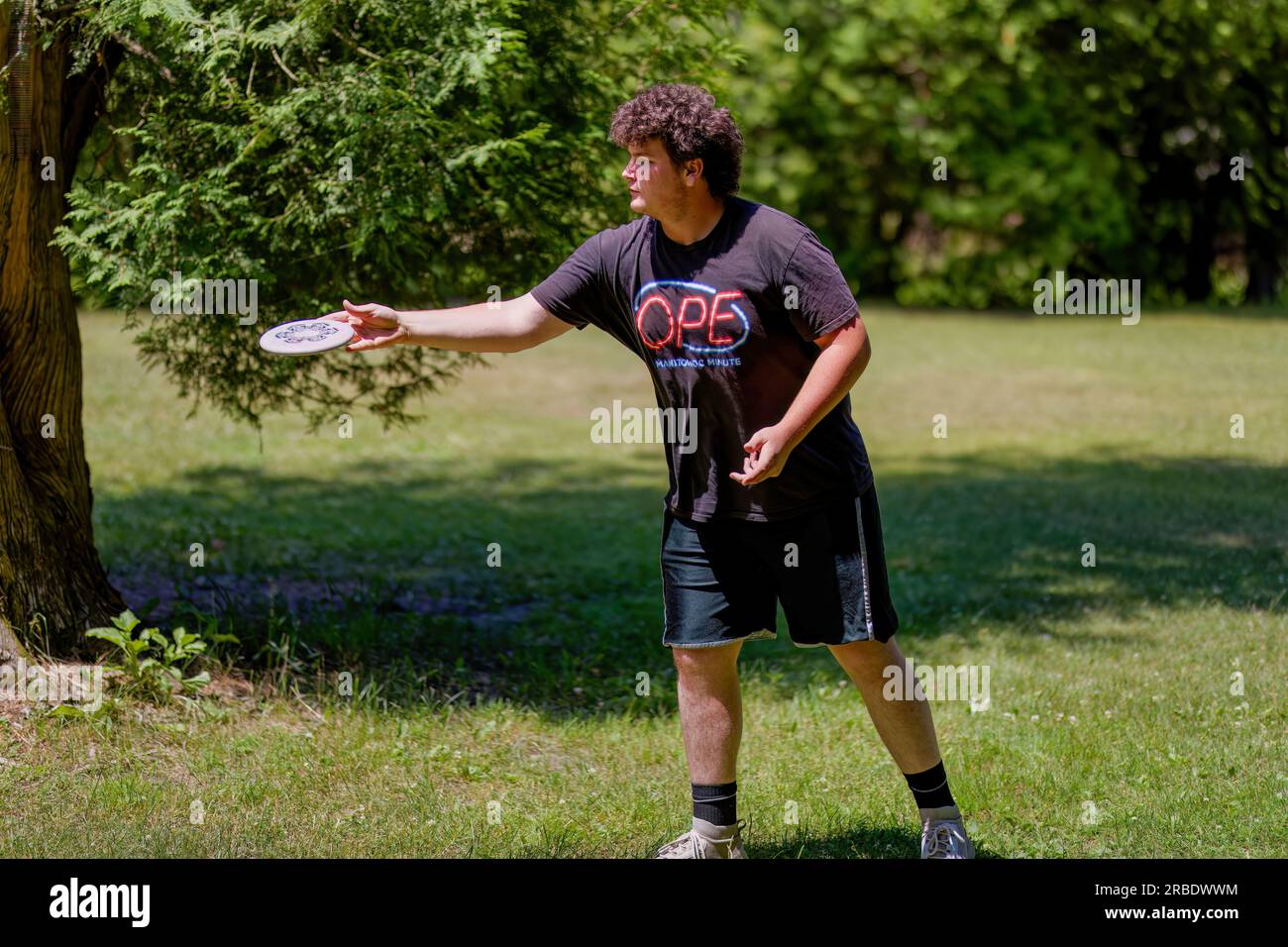 Manitowoc WI Disc golf. A player throwing a concave plastic disc into a ...