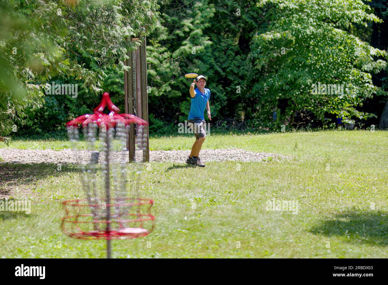 Manitowoc WI Disc golf. A player throwing a concave plastic disc into a ...