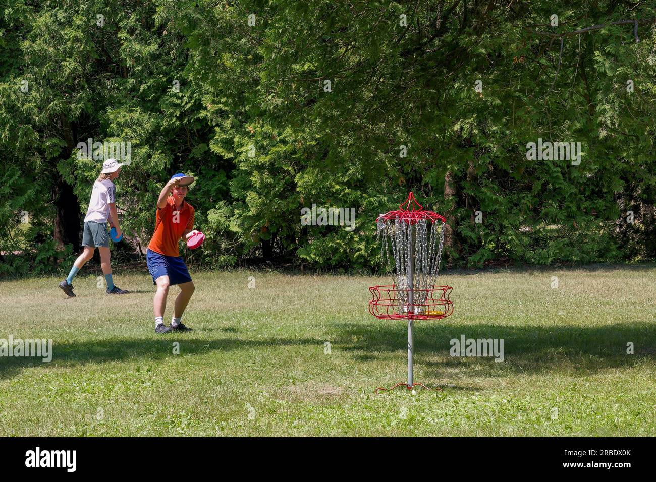 Manitowoc WI Disc golf. A player throwing a concave plastic disc into a ...