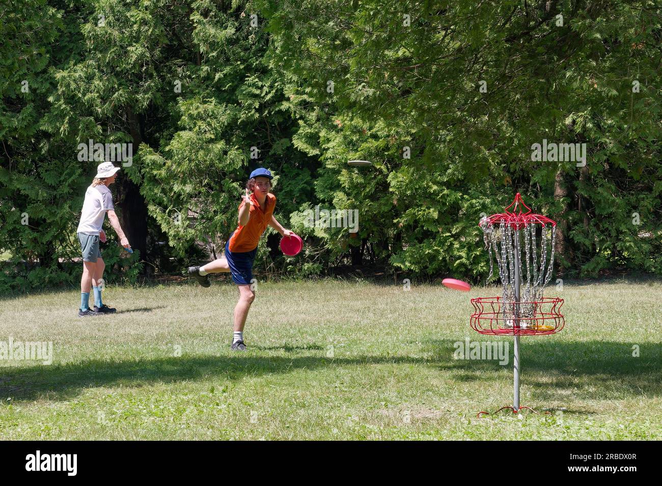 Manitowoc WI Disc golf. A player throwing a concave plastic disc into a ...