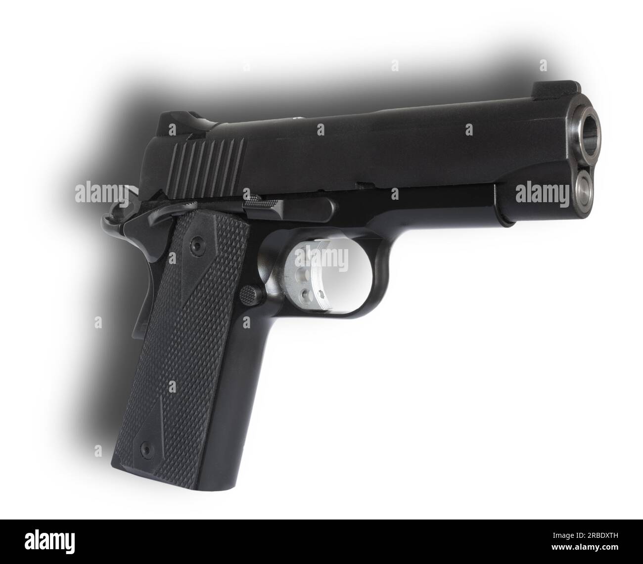 Shadow behind a 1911 semi-automatic pistol with skeletonized trigger ...