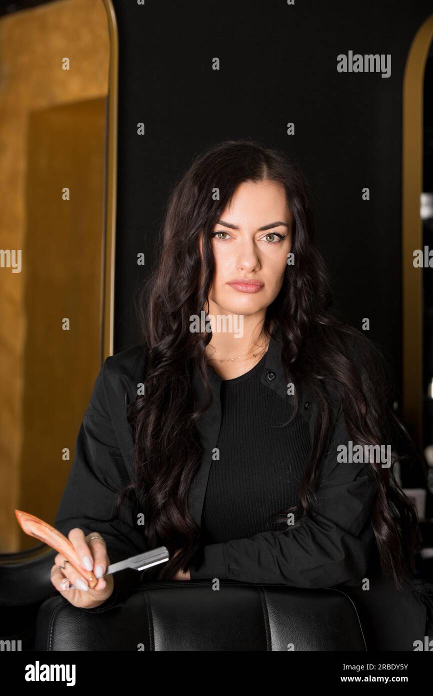 Beautiful young brutal woman male master hairdresser, barber holding ...