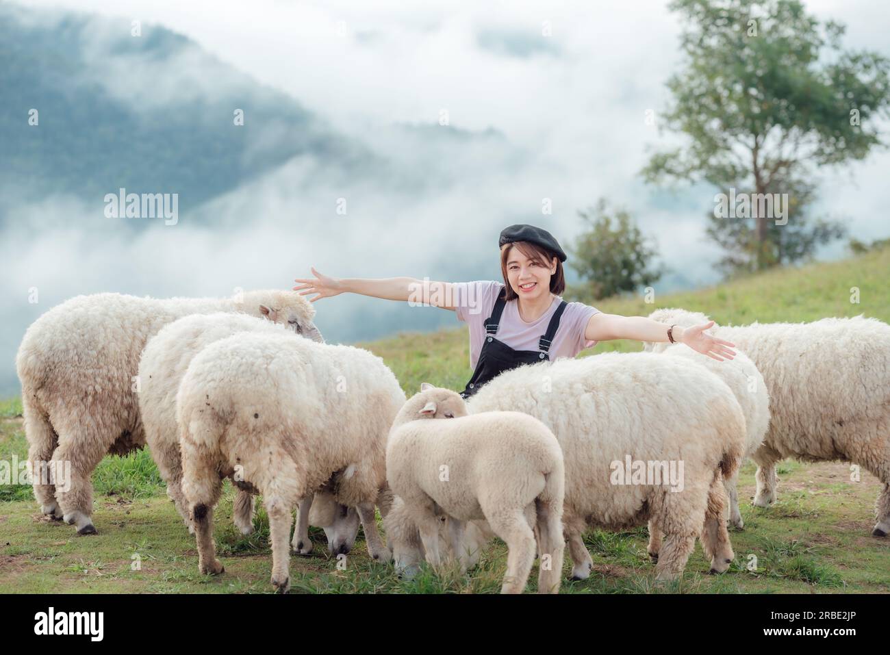 A happy moment of a female farmer and her sheep Stock Photo - Alamy