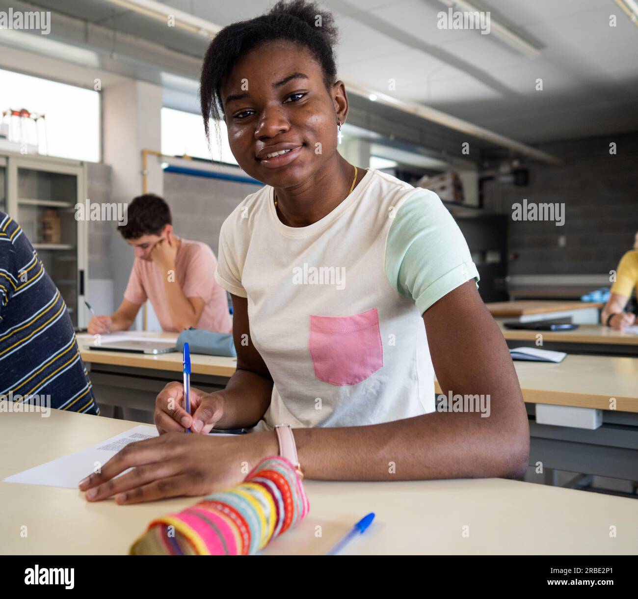 African american teenage student girl in class looking at camera ...
