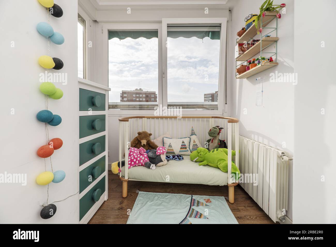 A beautiful children's bedroom with an open crib with several stuffed ...