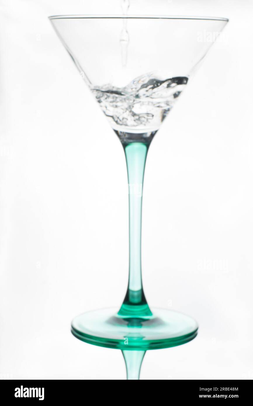 martine glass with green details and moving liquid Stock Photo - Alamy