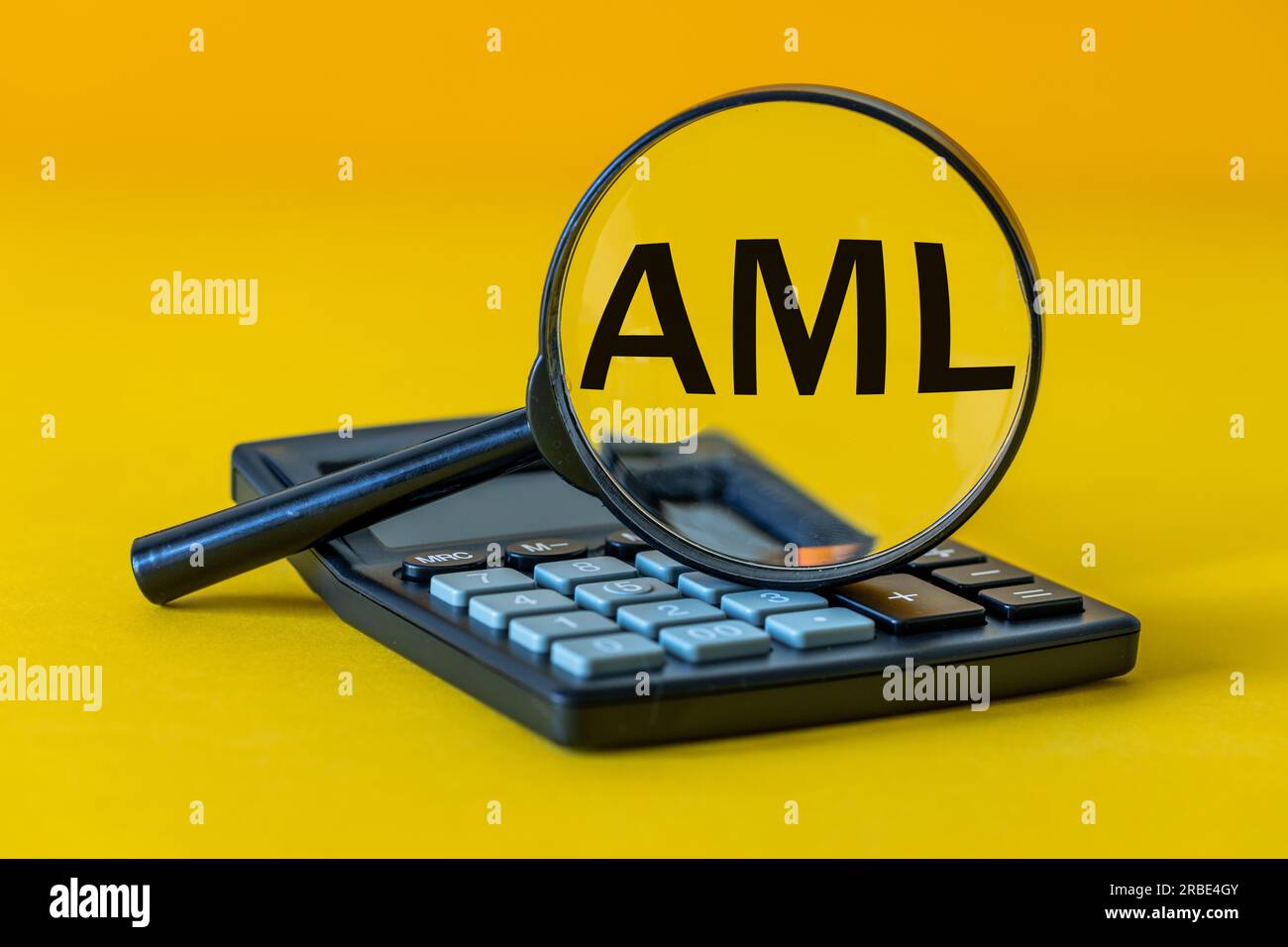 Black calculator and magnifying glass AML text, Beautiful yellow ...