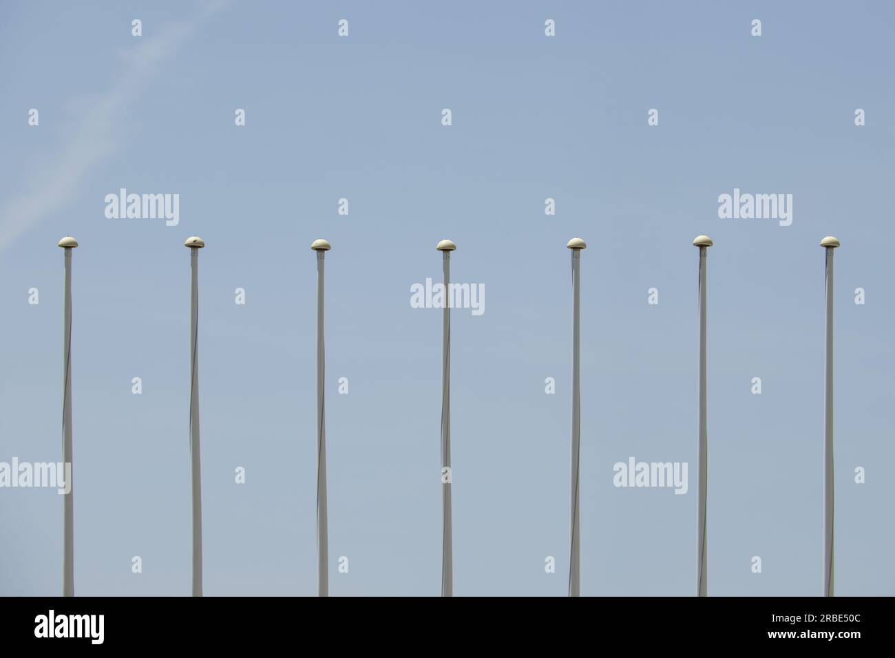 Empty poles to hold flags and flutter in the wind Stock Photo - Alamy