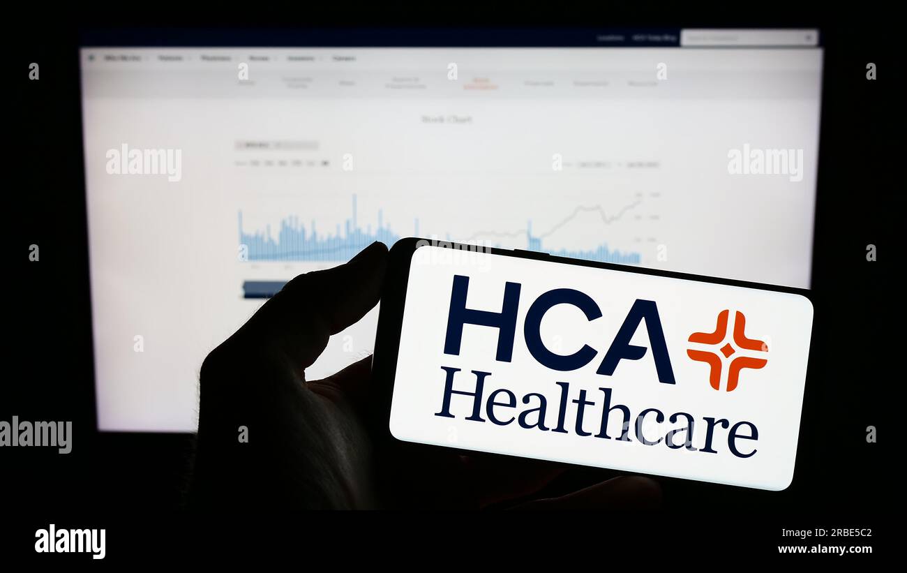 Person holding cellphone with logo of US company HCA Healthcare Inc. on ...
