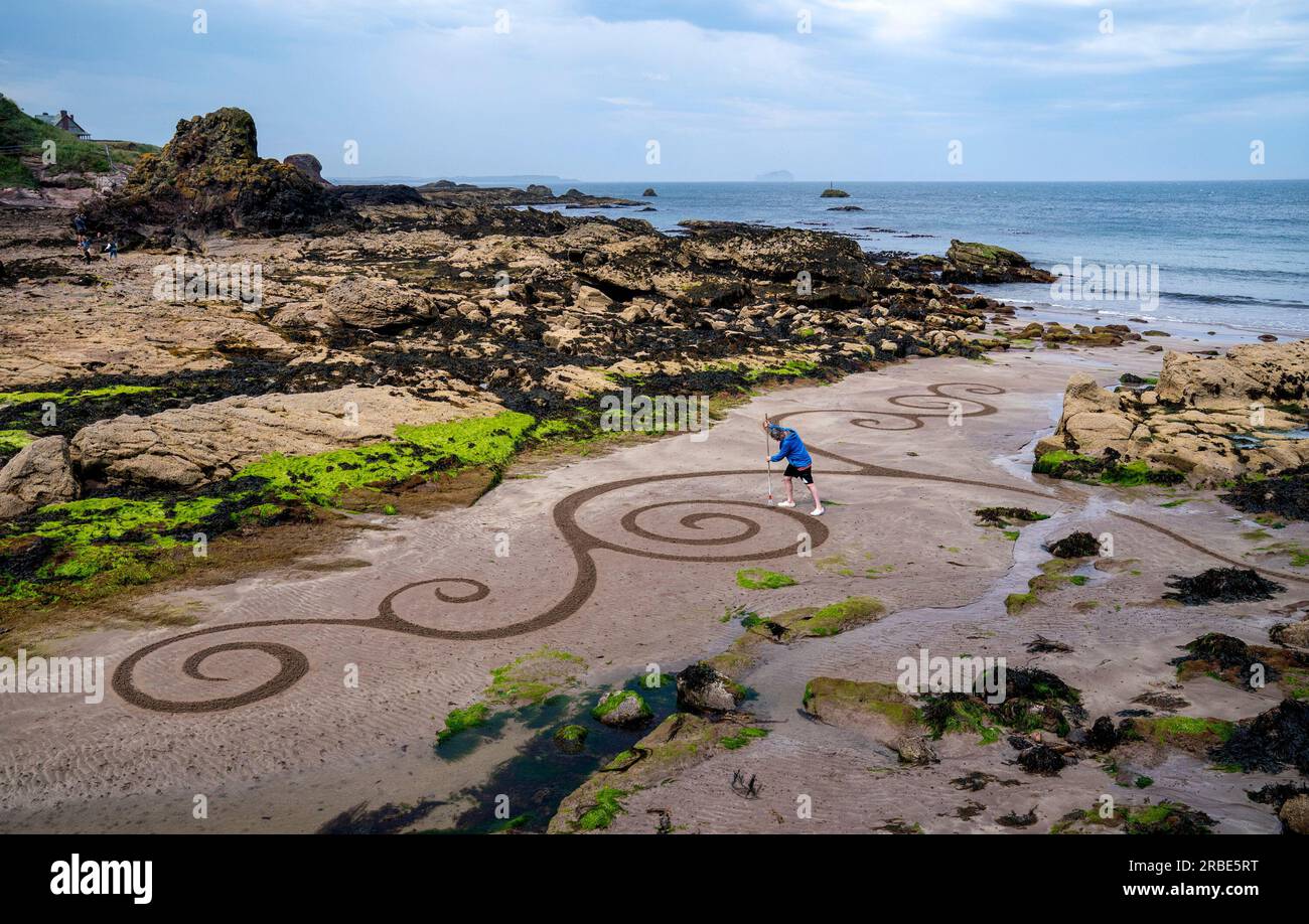Artist Sean Corcoran, from Waterford, Ireland, creates a piece of sand ...