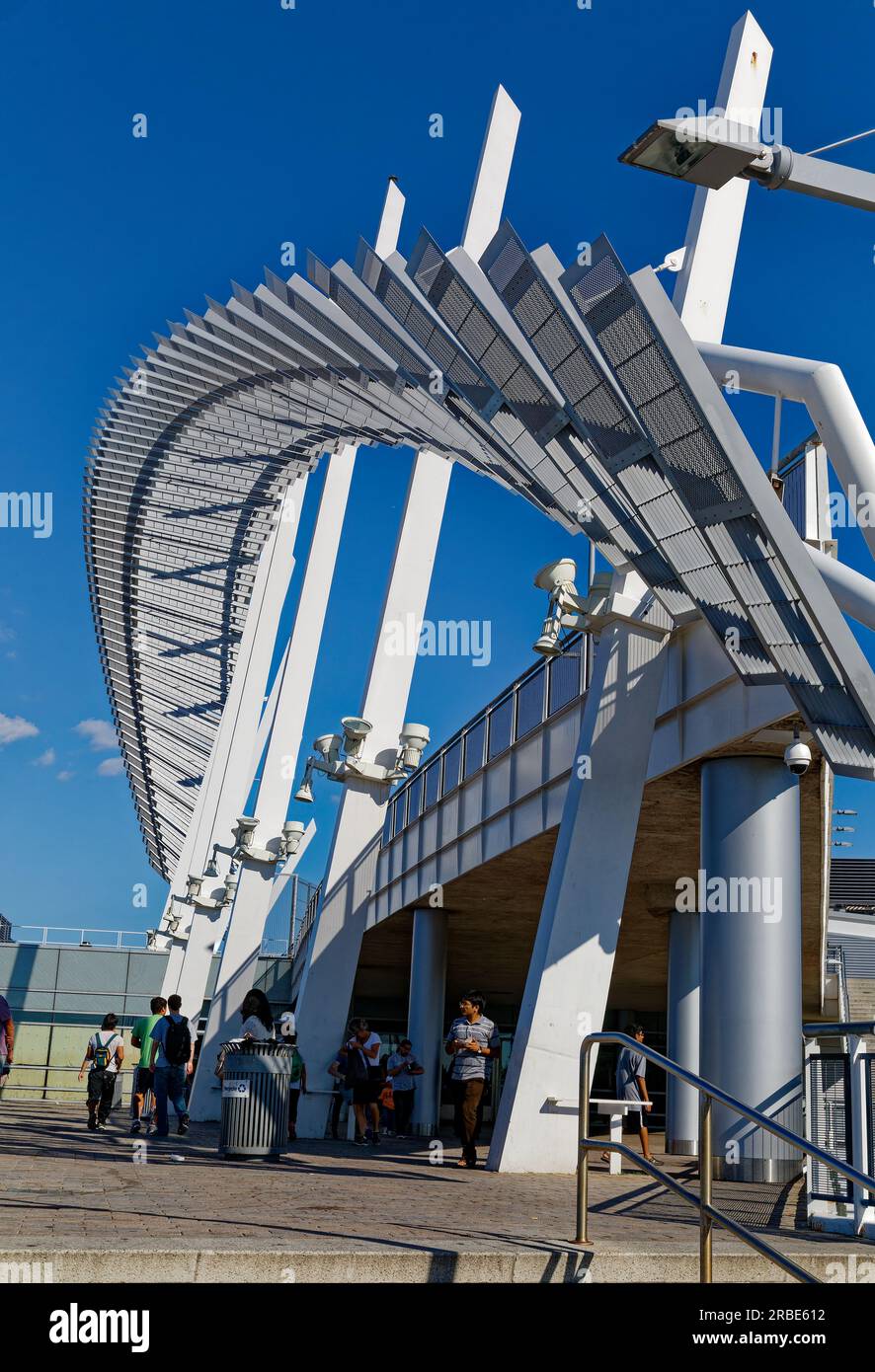 Brilliant white against a blue sky, a steel-panel arch soars above the ...