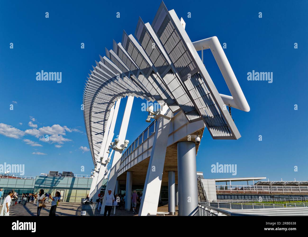 Brilliant white against a blue sky, a steel-panel arch soars above the ...