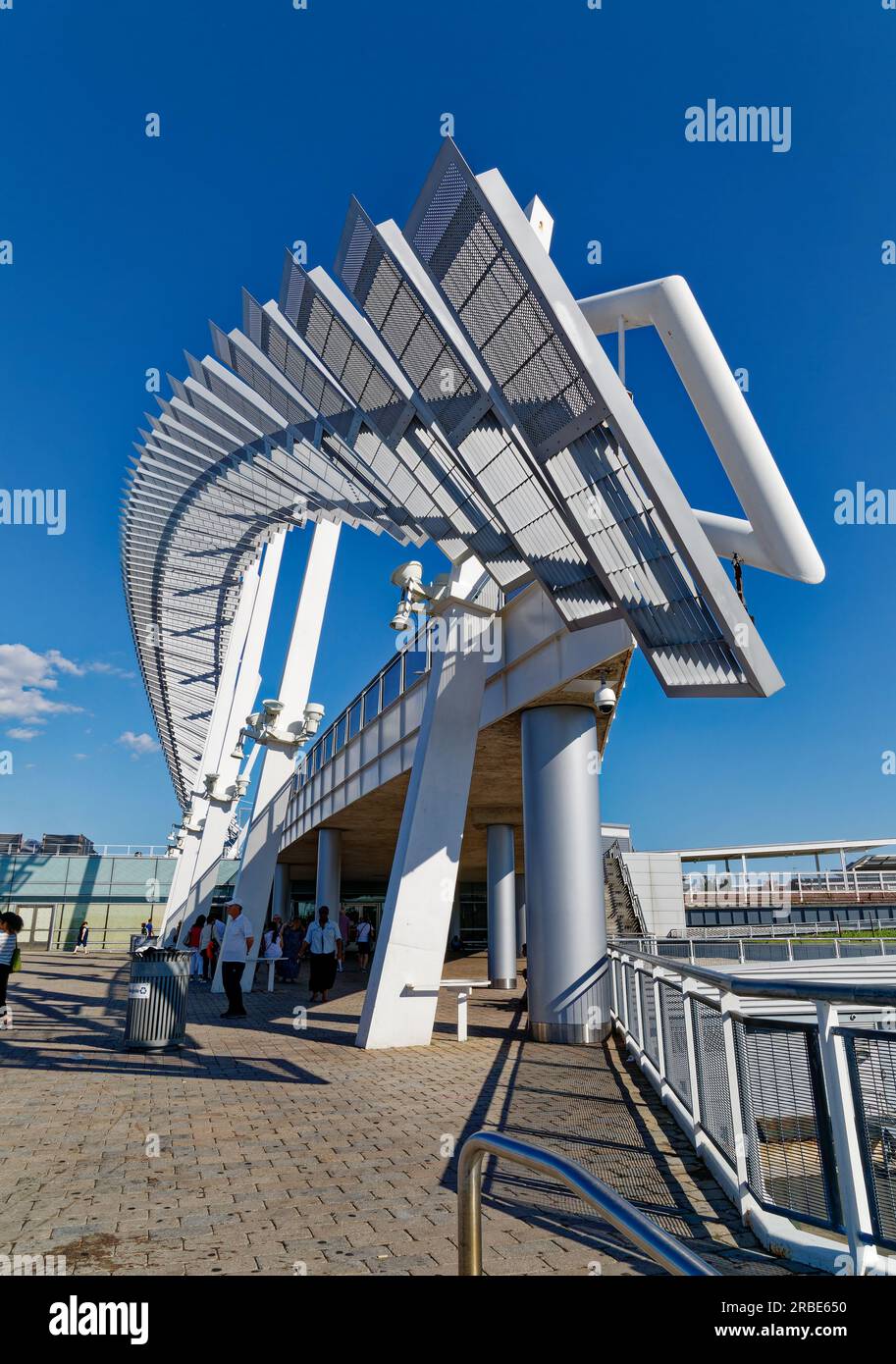 Brilliant white against a blue sky, a steel-panel arch soars above the ...