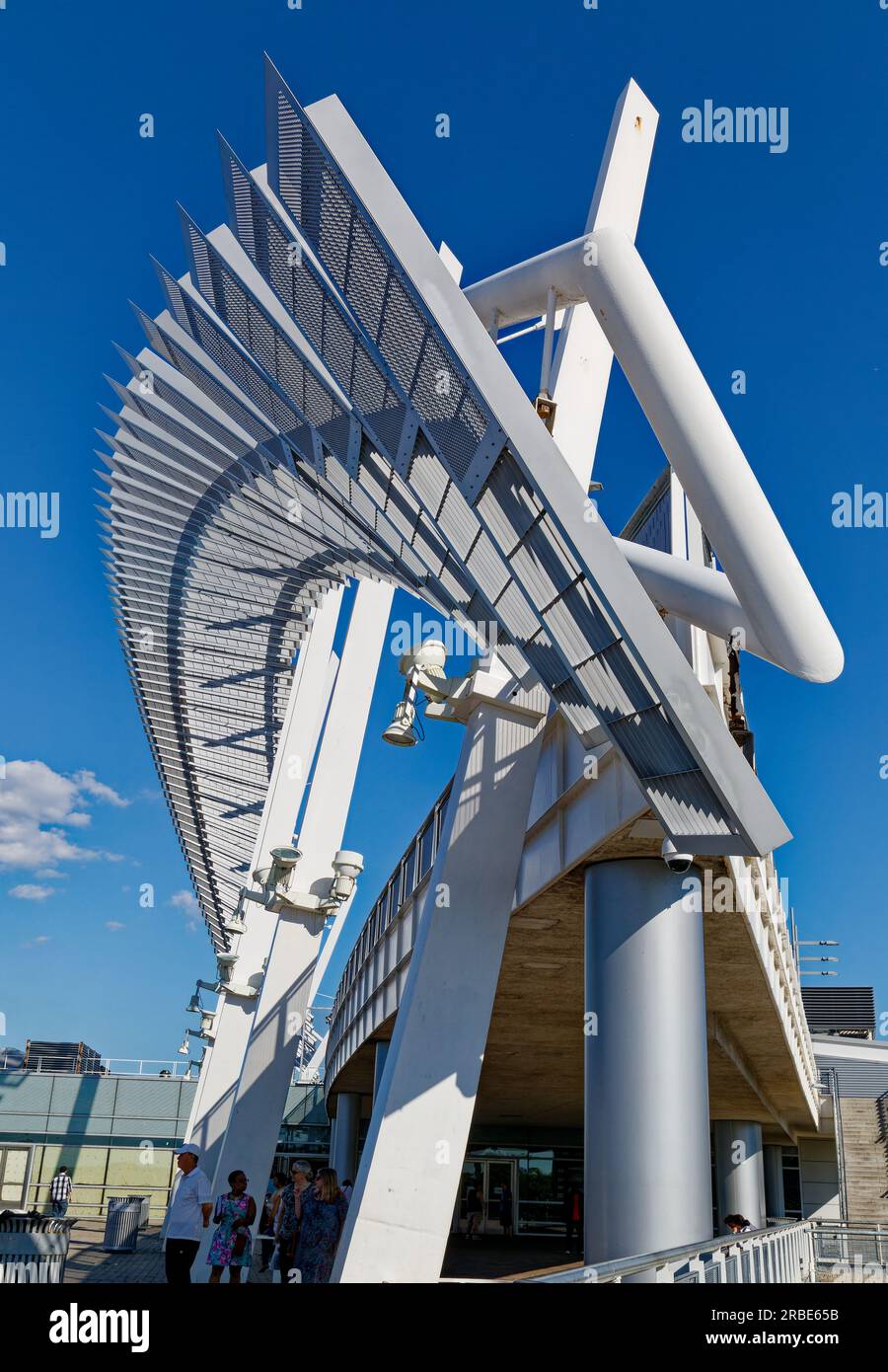 Brilliant white against a blue sky, a steel-panel arch soars above the ...