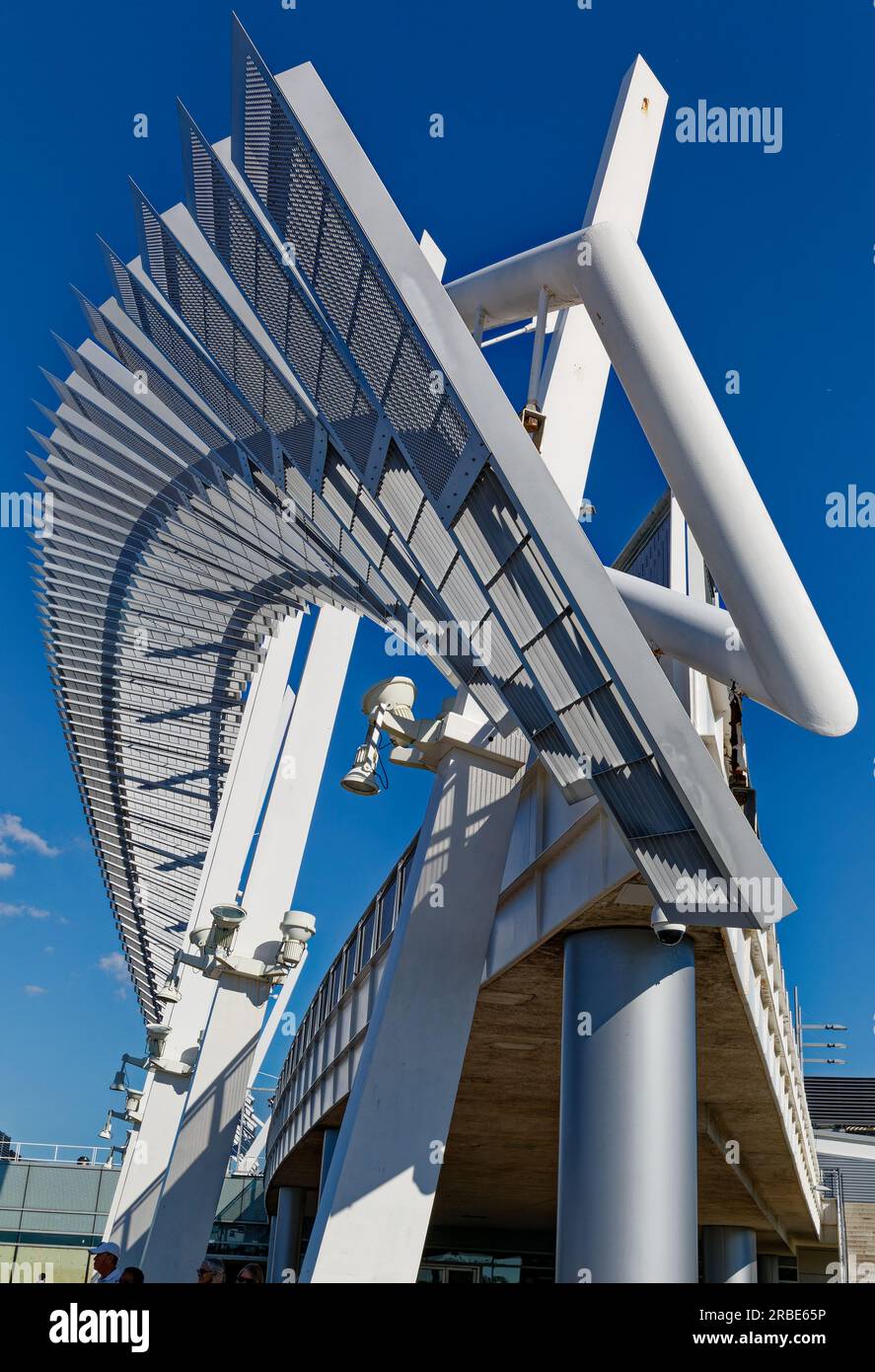 Brilliant white against a blue sky, a steel-panel arch soars above the ...