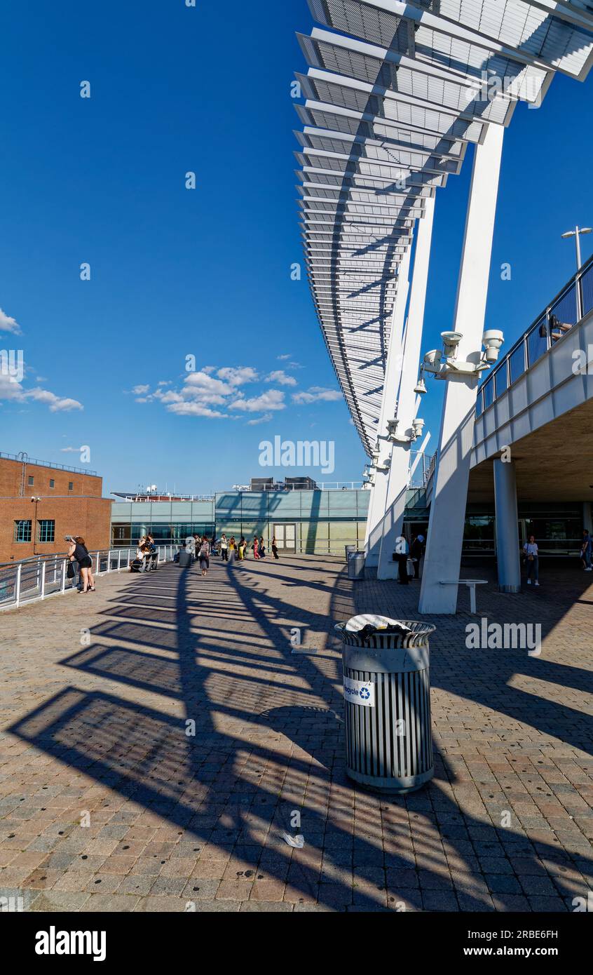 Brilliant white against a blue sky, a steel-panel arch soars above the ...