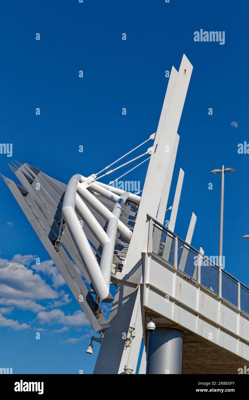 Brilliant white against a blue sky, a steel-panel arch soars above the ...