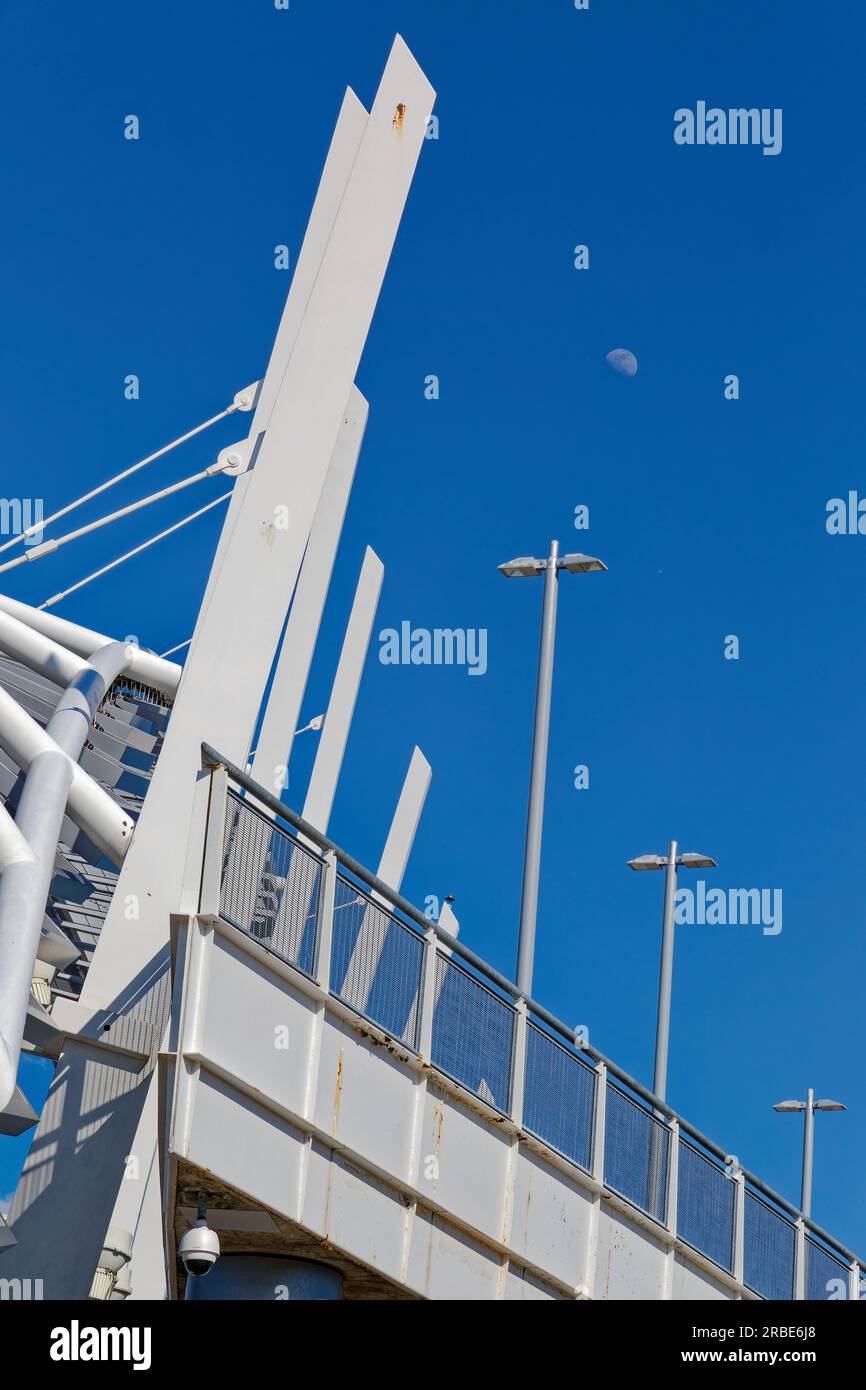 Brilliant white against a blue sky, a steel-panel arch soars above the ...