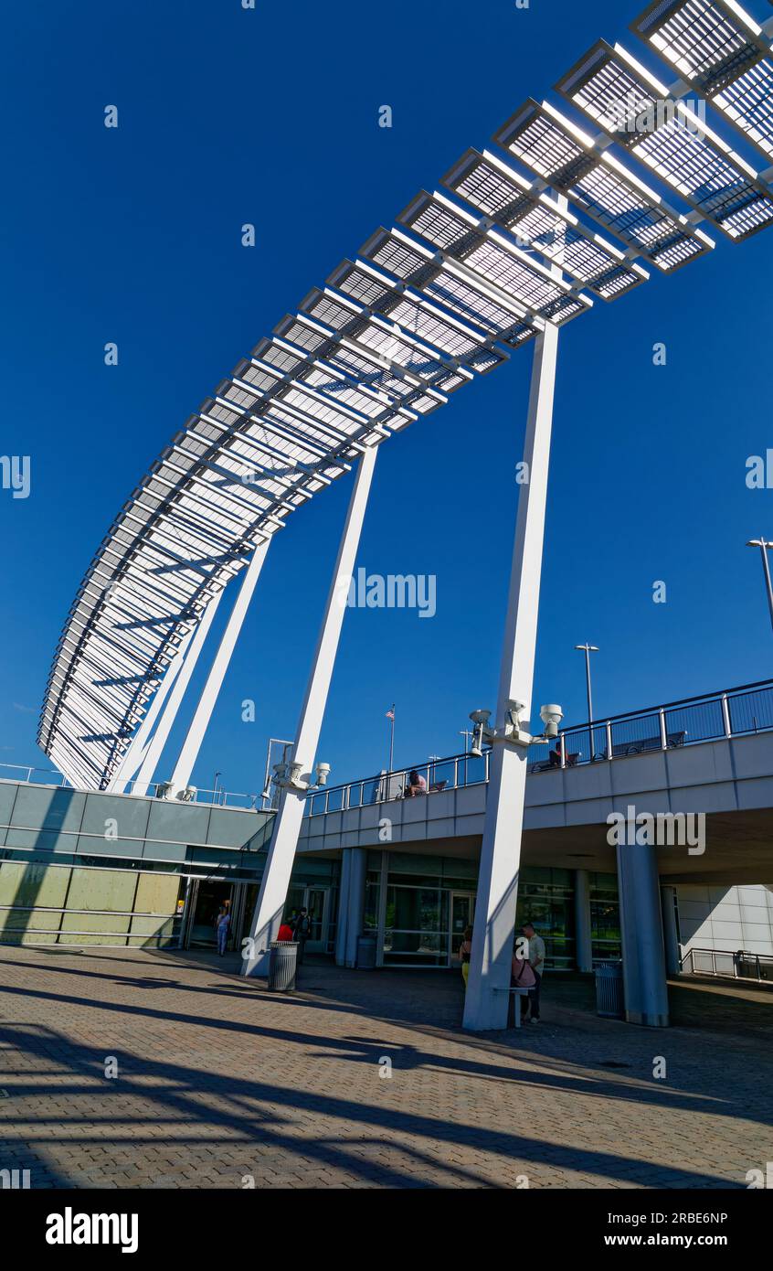 Brilliant white against a blue sky, a steel-panel arch soars above the ...