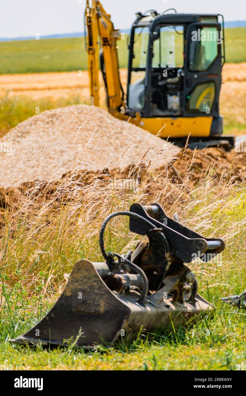 Mini digger and bucket, exterior works Stock Photo - Alamy