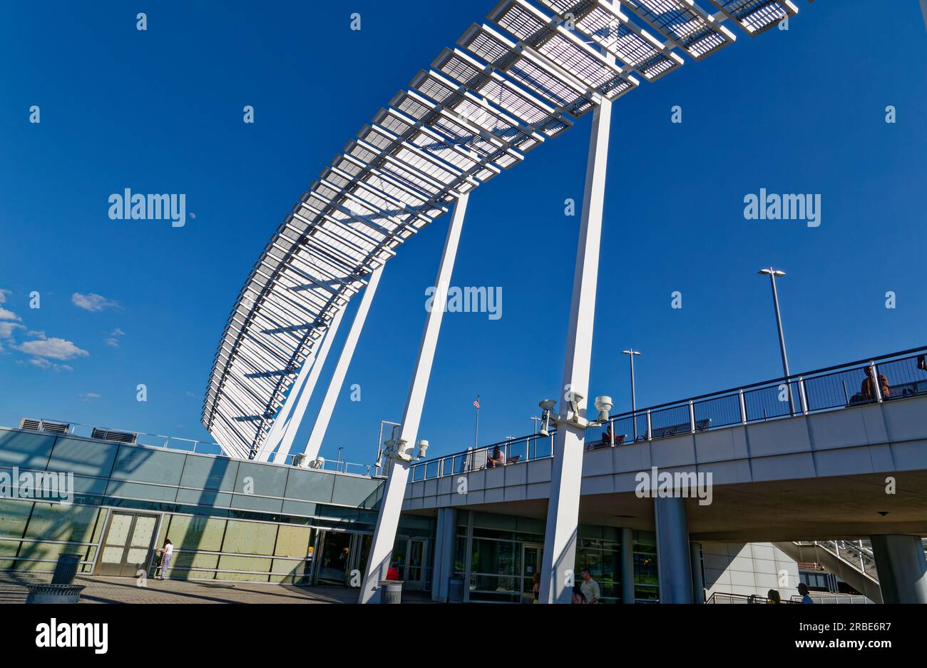 Brilliant white against a blue sky, a steel-panel arch soars above the ...