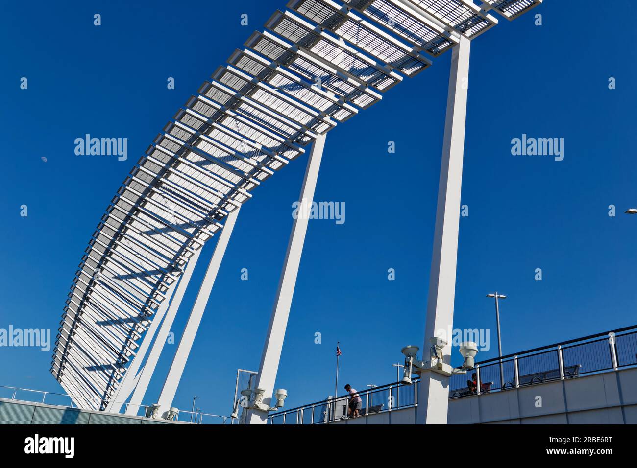 Brilliant white against a blue sky, a steel-panel arch soars above the ...
