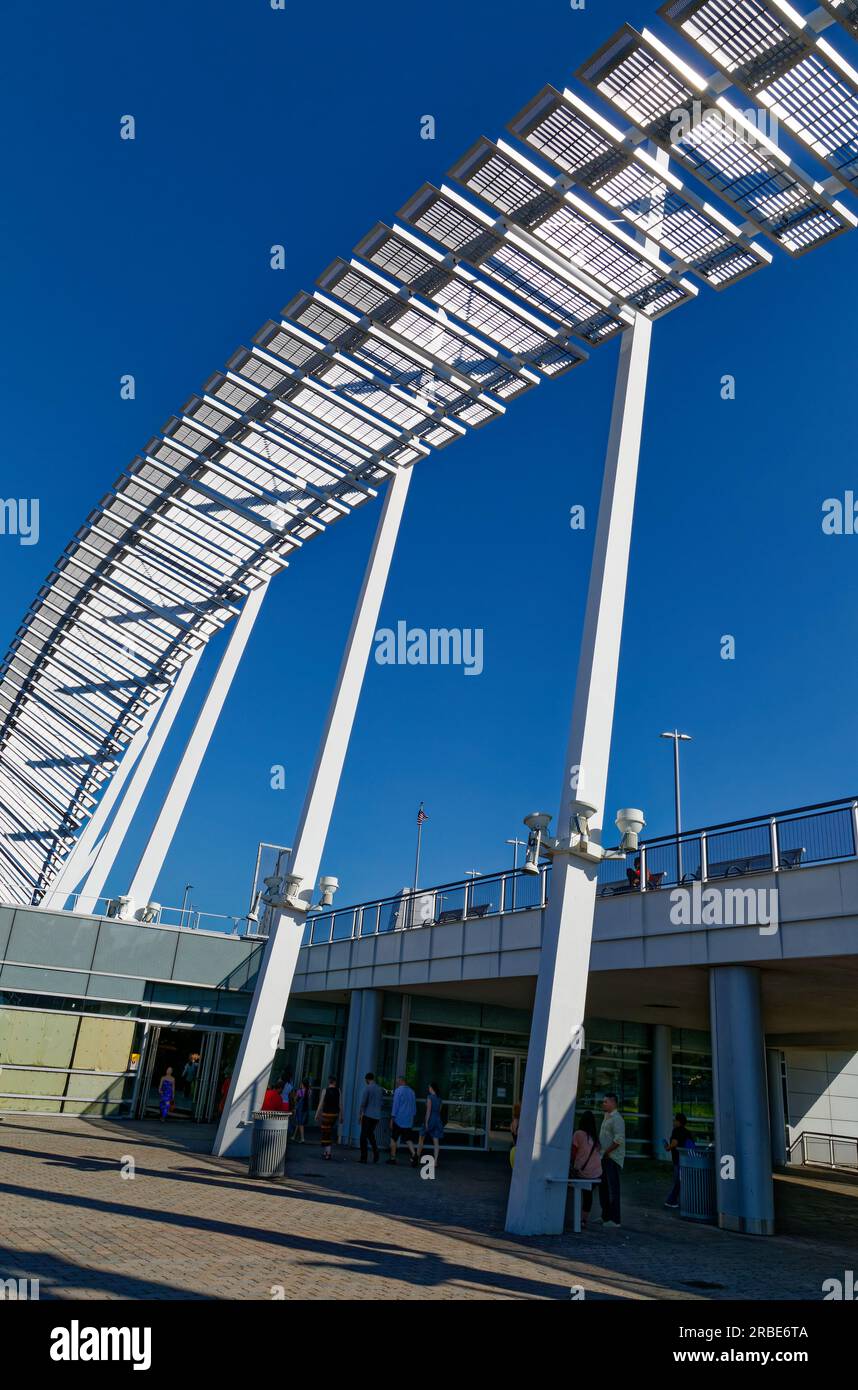 Brilliant white against a blue sky, a steel-panel arch soars above the ...
