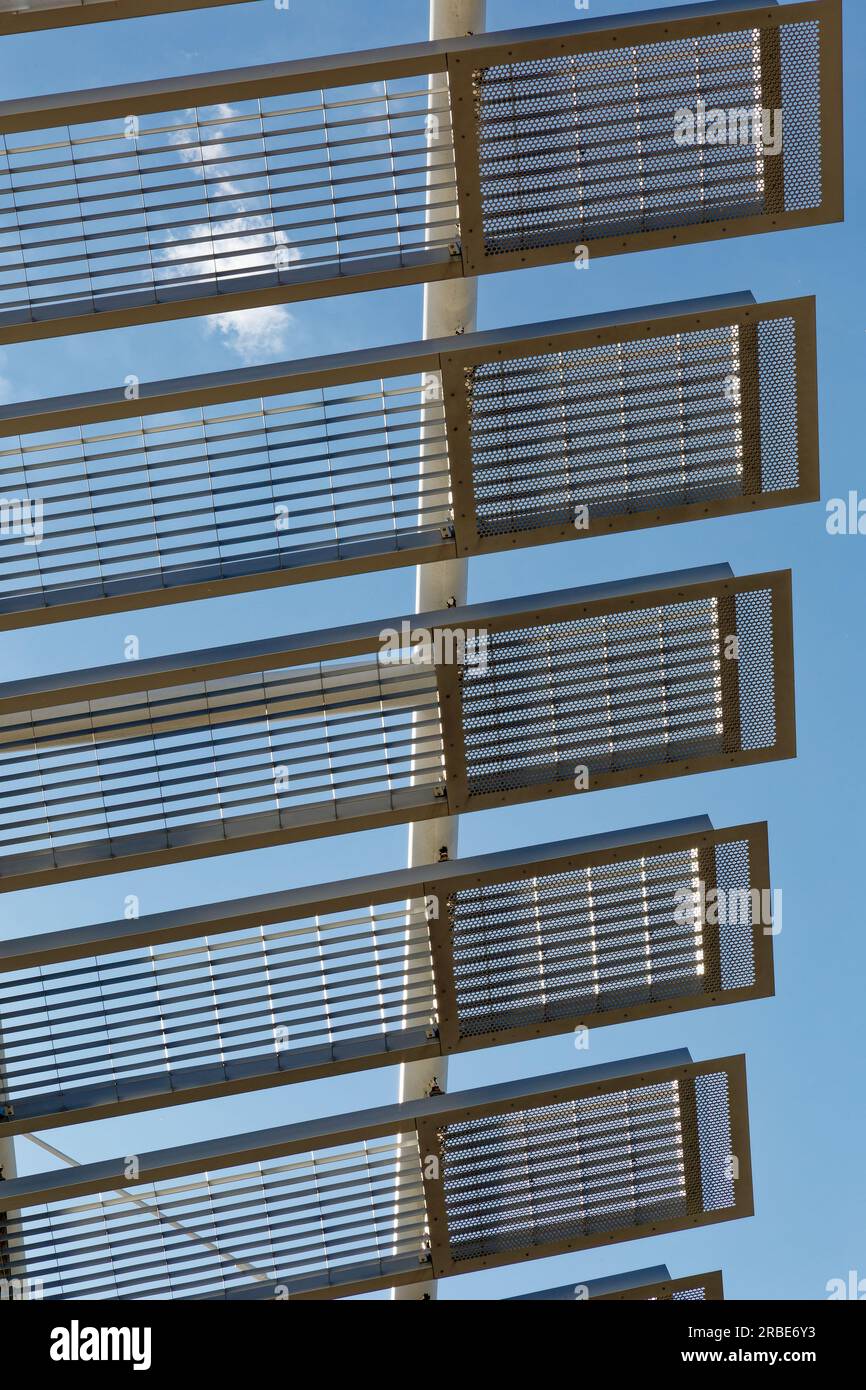 Brilliant white against a blue sky, a steel-panel arch soars above the ...