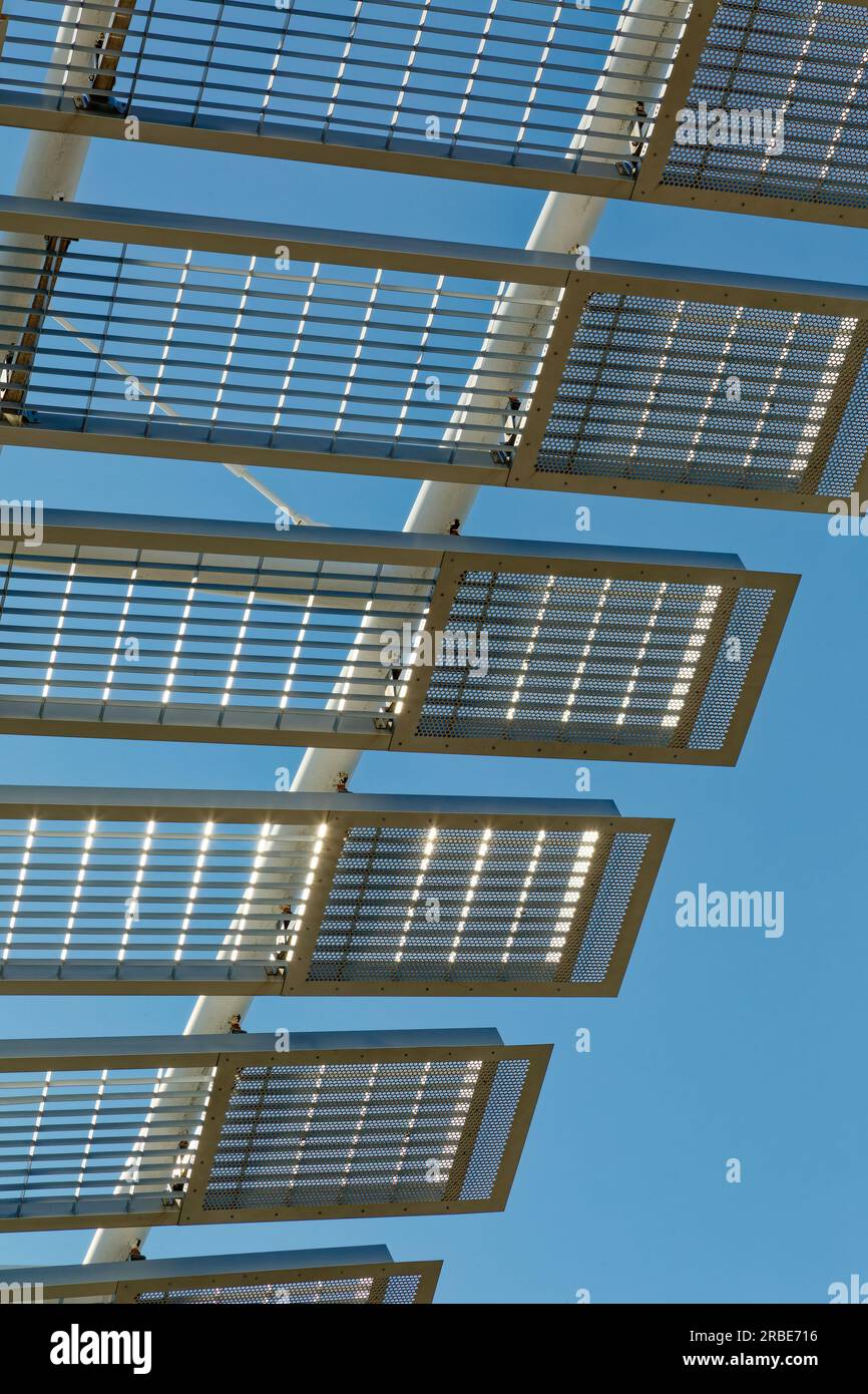 Brilliant white against a blue sky, a steel-panel arch soars above the ...