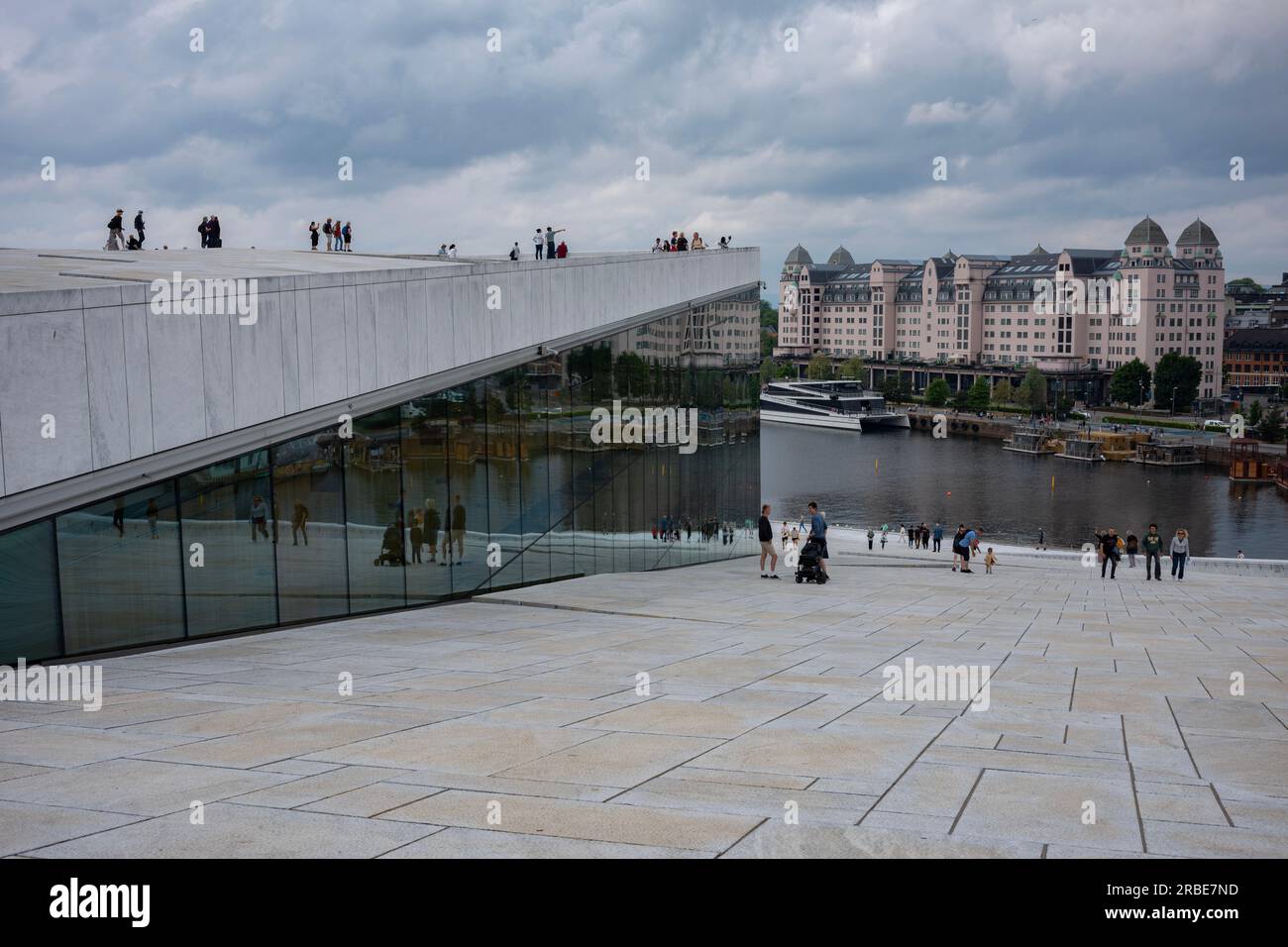 Oslo, Norway, June 19, 2023: Tourists explore the Oslo Opera House on a ...