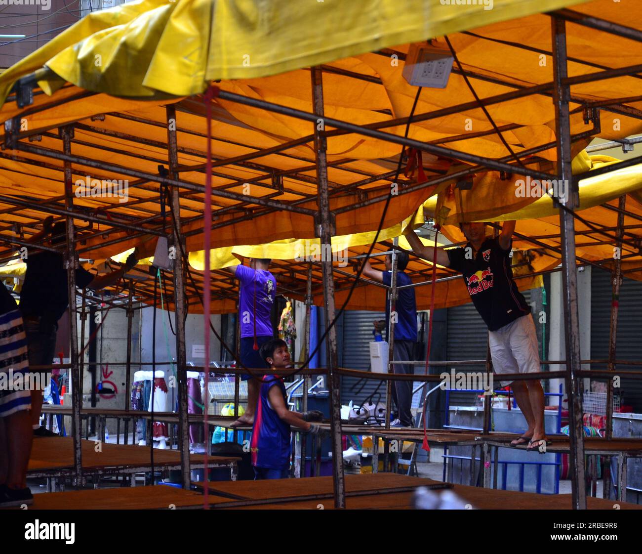 Young men assemble the stall structures of Patong Night Market, on ...