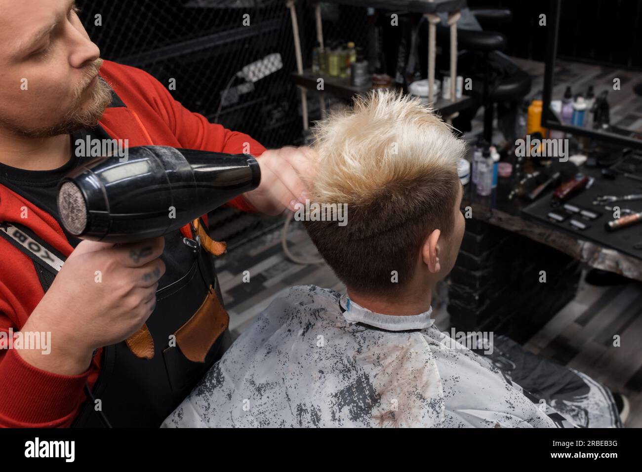 Barber drying client hair dryer hi-res stock photography and images - Alamy