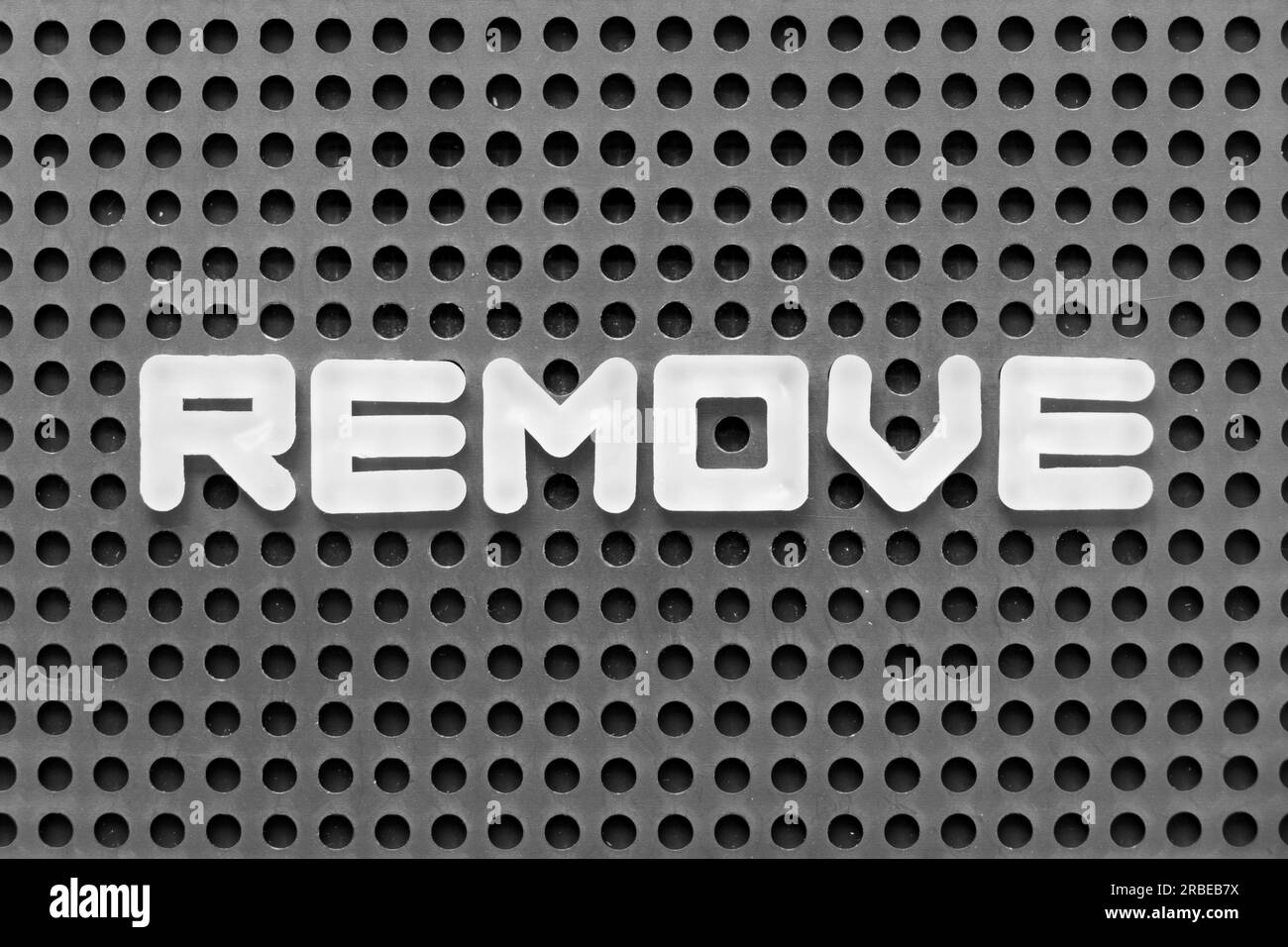 White alphabet letter in word remove on black pegboard background Stock ...