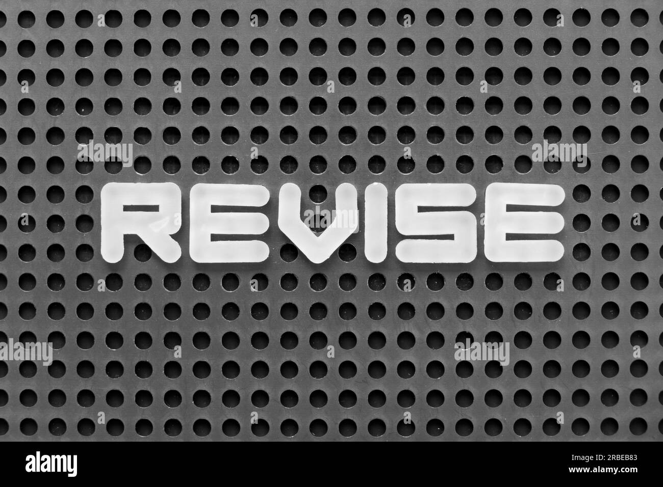 White alphabet letter in word revise on black pegboard background Stock ...