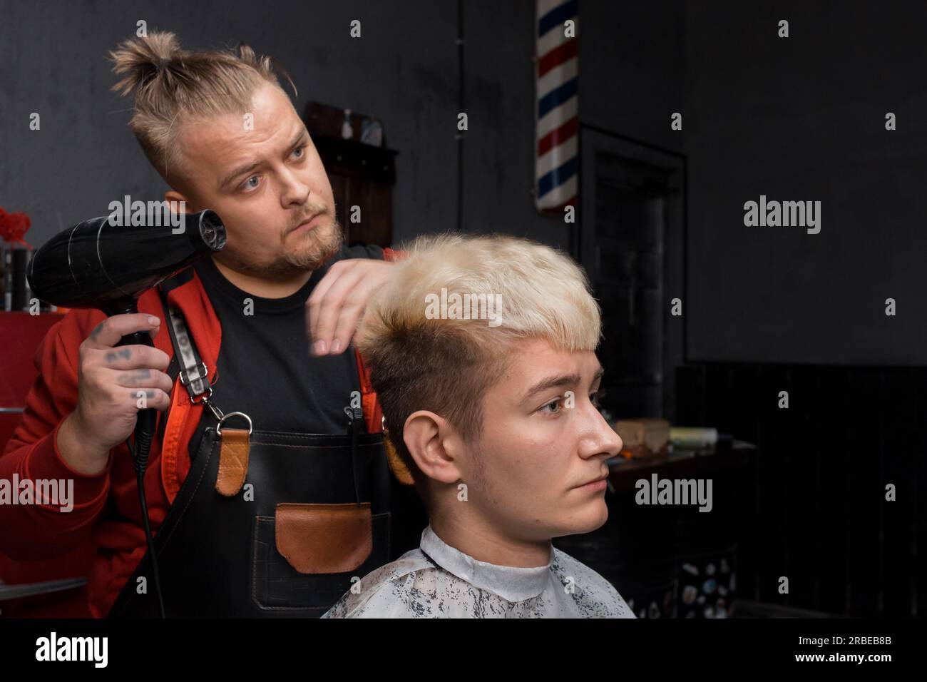 Male barber working in barbershop hi-res stock photography and images ...