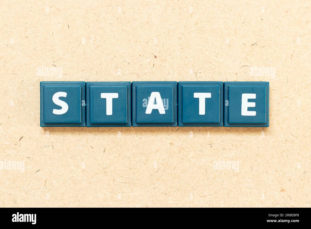 Tile alphabet letter in word state on wood background Stock Photo - Alamy
