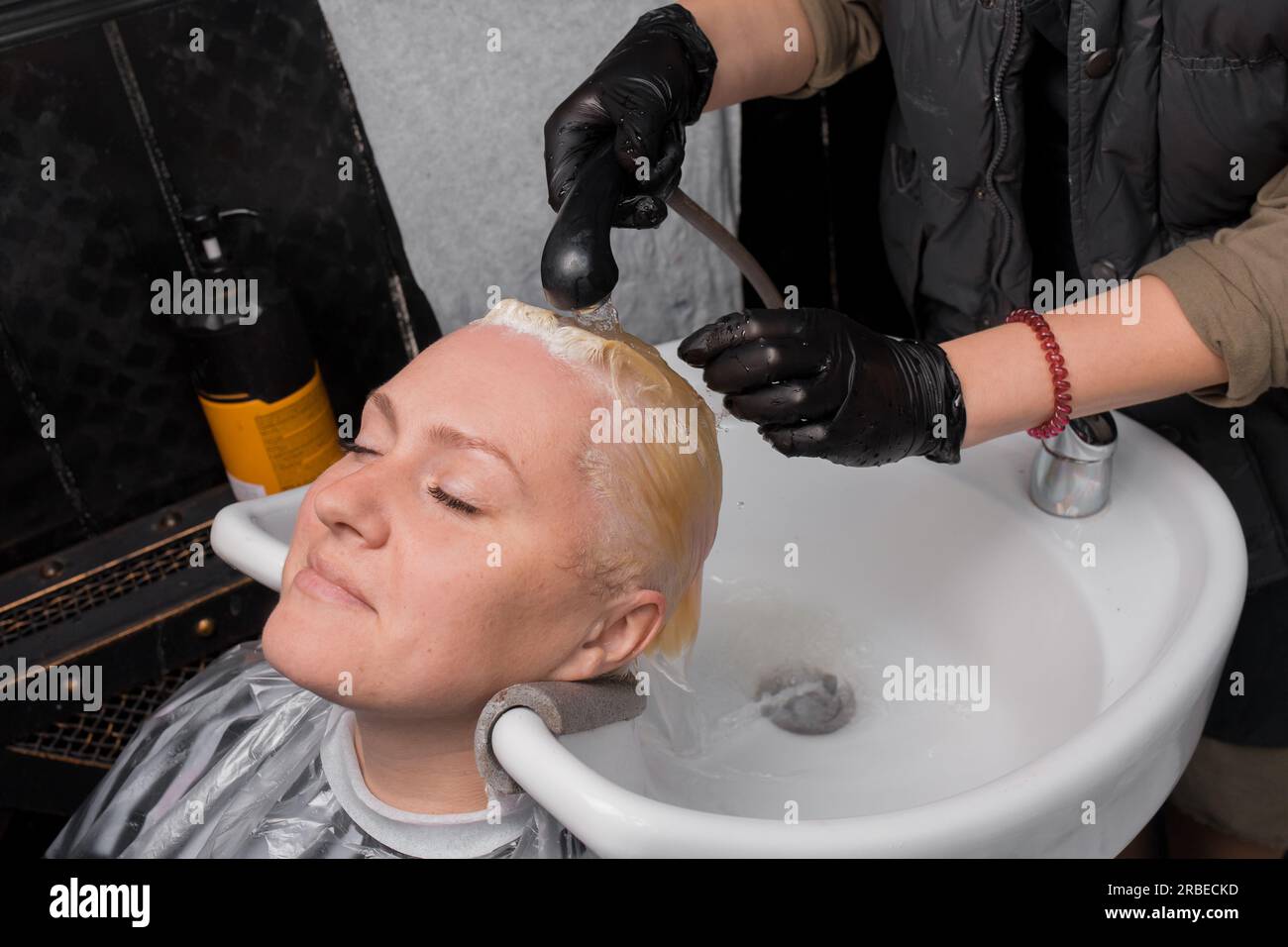 The process of washing off the dye after dyeing the hair with rain over ...