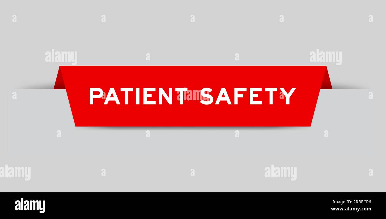 Red color inserted label with word patient safety on gray background ...