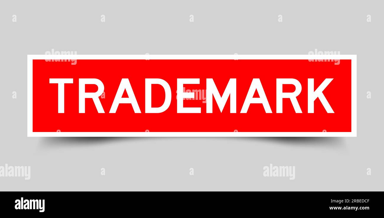 Red color square shape sticker label with word trademark on gray ...