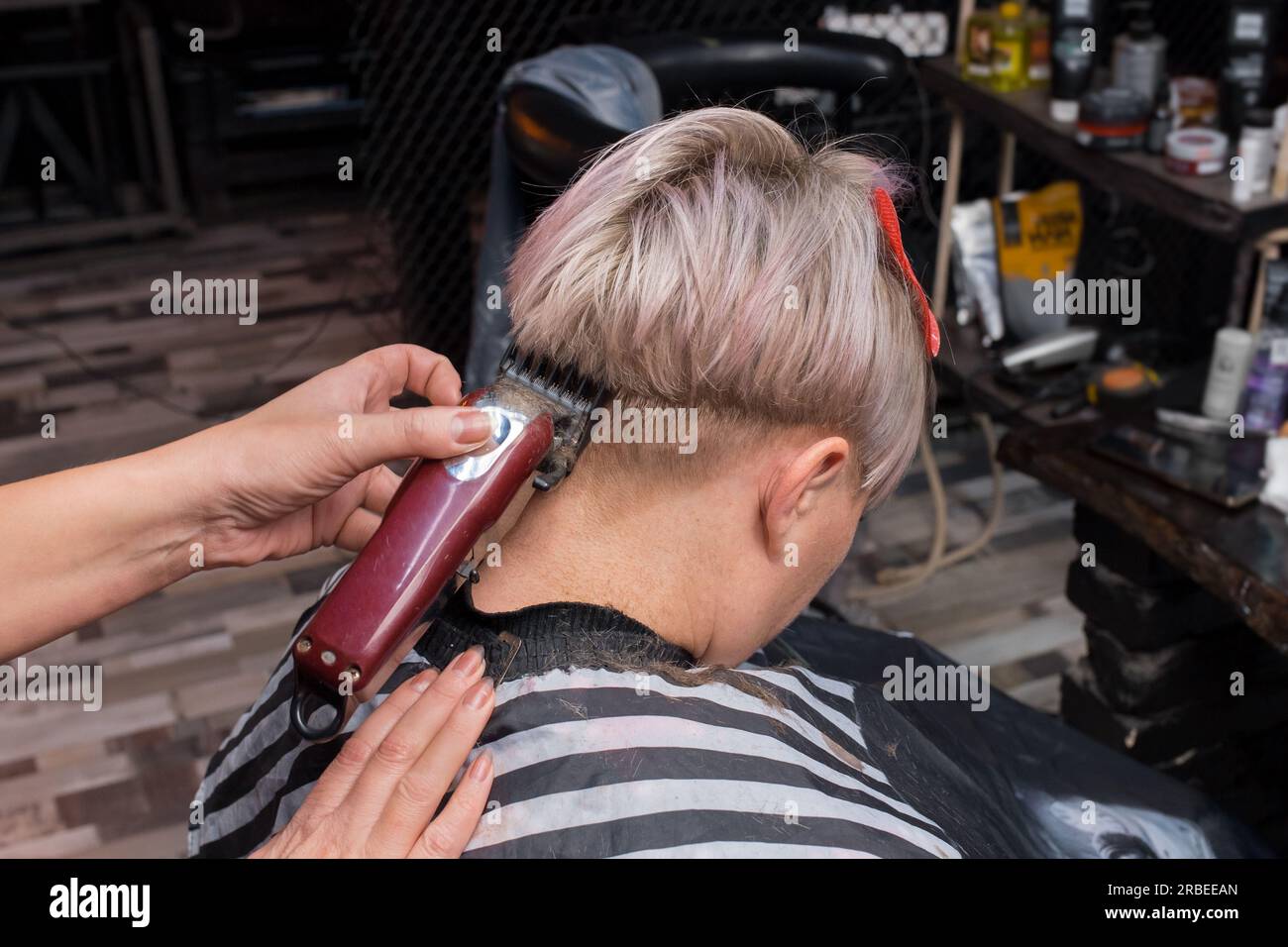The hands of a girl of an experienced hairdressing salon worker, cut ...