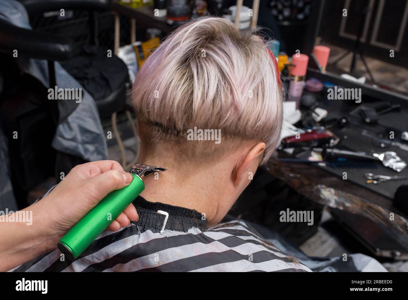The hand of a girl of a professional in her field, the salon cuts the ...