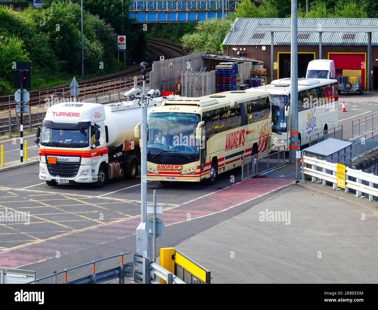 Tour buses and lorry, tanker, waiting to board ferry to the Isle of ...