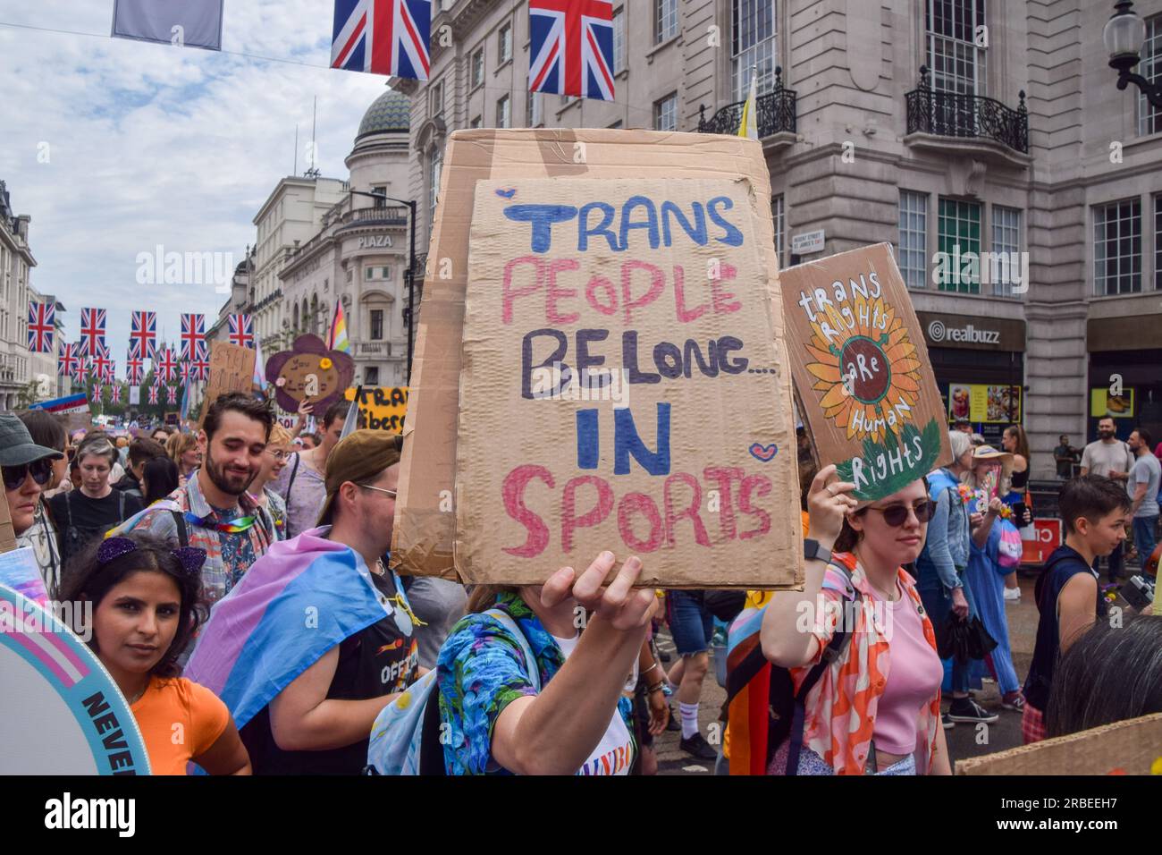 London, UK. 08th July, 2023. A protester holds a 'Trans people belong ...