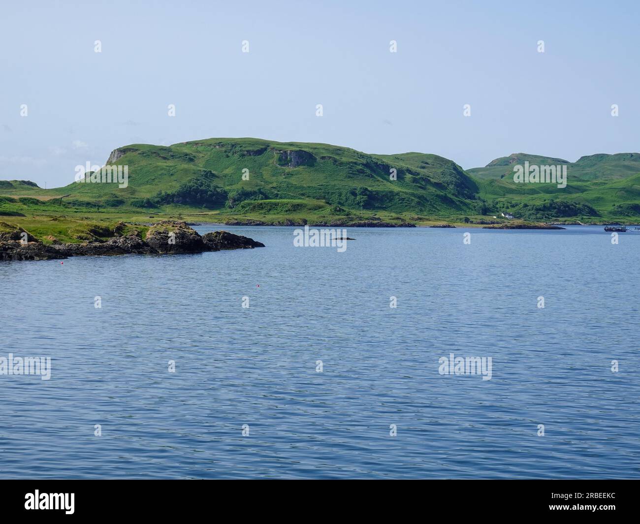 Green hills, rocky coast, grass covered Isle of Kerrera, Inner Hebrides ...