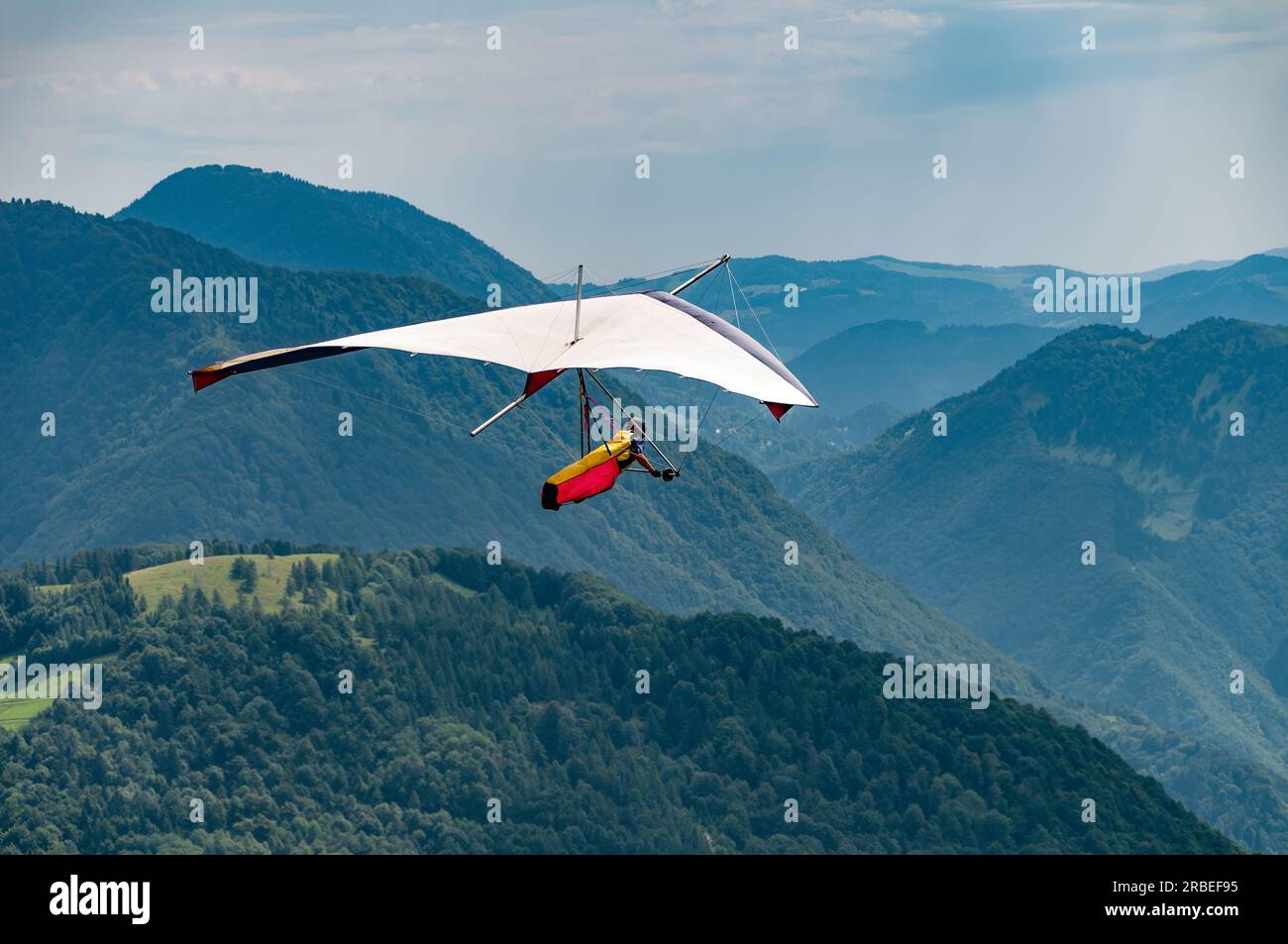 Vintage hang glider flies in the mountains in Soca valley. Extreme ...