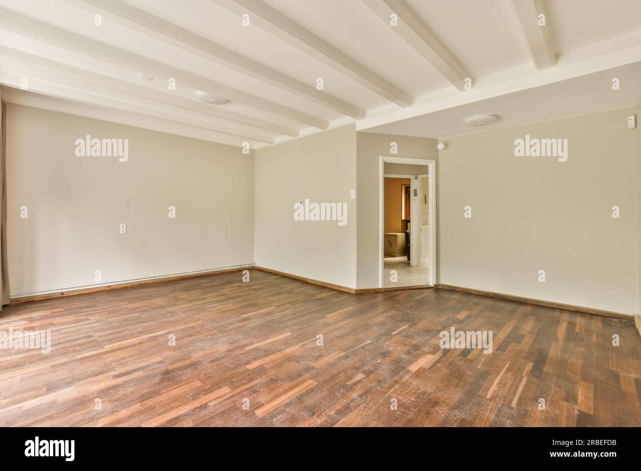 an empty living room with hardwood flooring and white painted ceiling ...