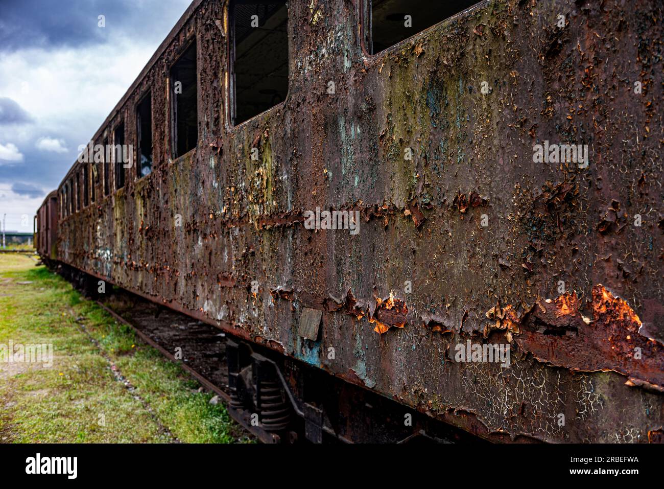 Old rusty passenger railway carriage abandoned on train cemetary field ...